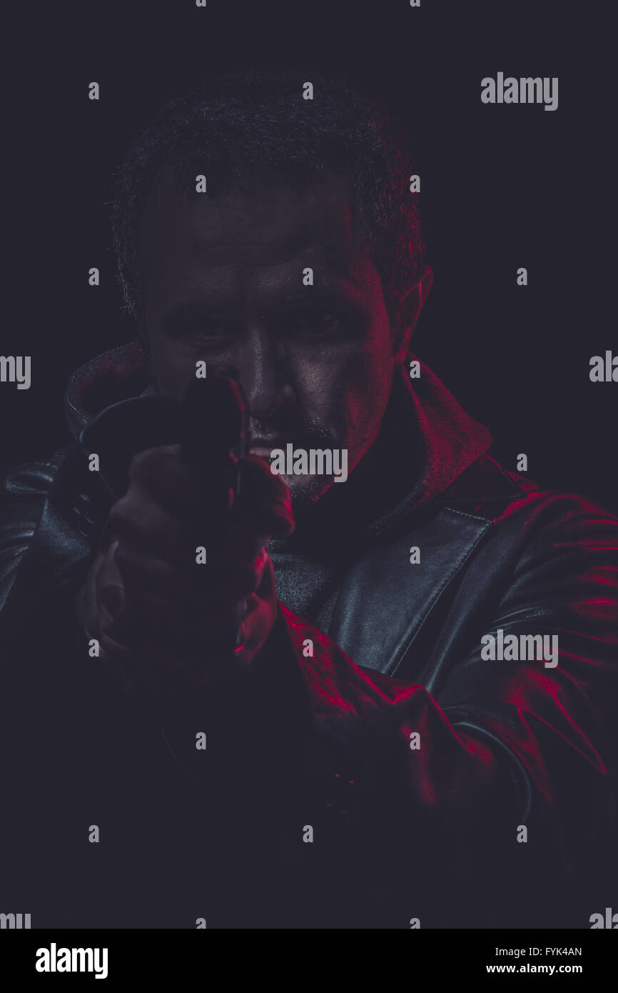 Secret Assassin, man with black coat and gun Stock Photo - Alamy