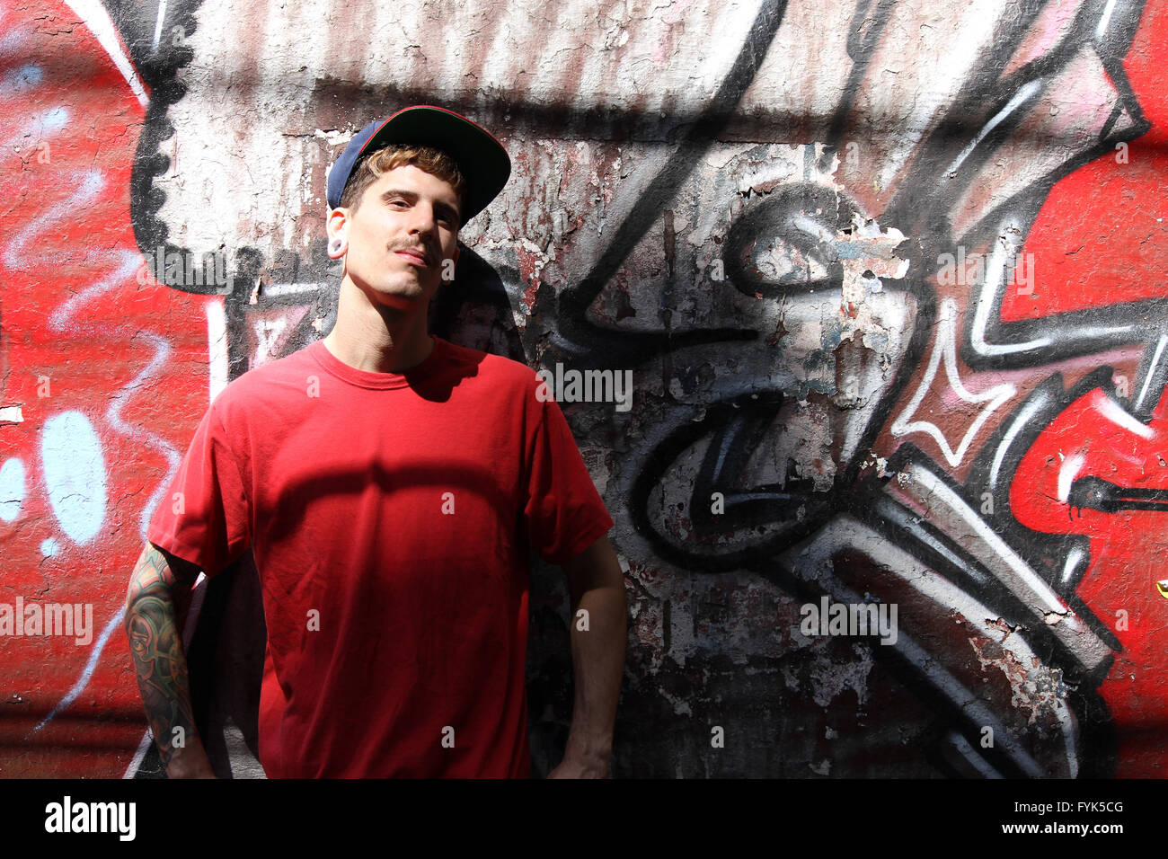 Rapper leaning on a Wall Stock Photo - Alamy