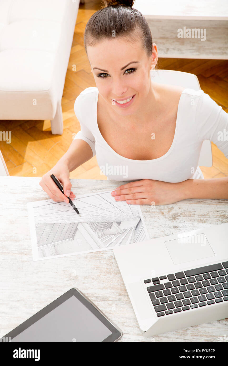 Woman drawing a blueprint Stock Photo - Alamy