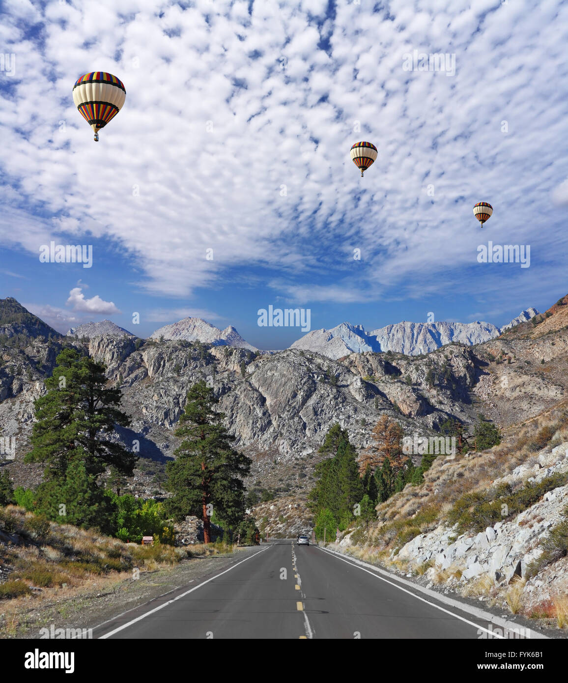 Huge balloons with the basket flying over the road Stock Photo - Alamy
