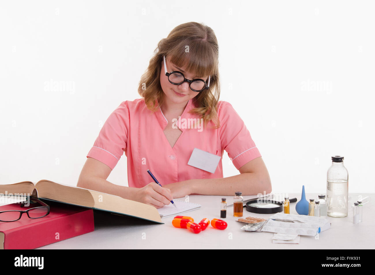 Pharmacist reading guide writes notes in a notebook Stock Photo - Alamy