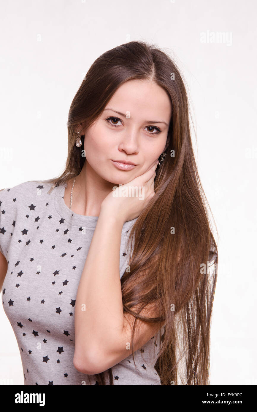 Beautiful girl with long hair holds a hand on the neck Stock Photo - Alamy