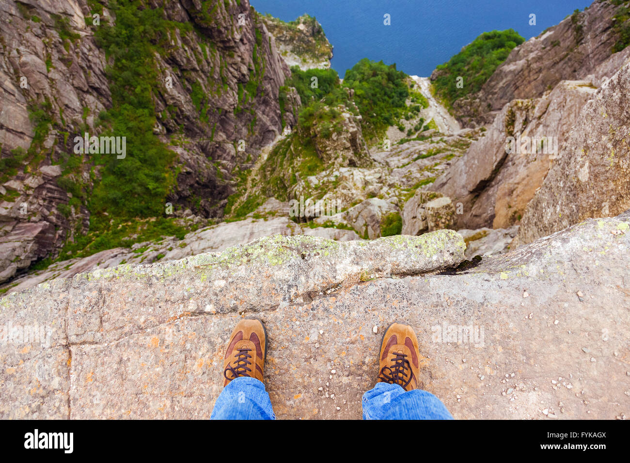 Man standing on cliff Preikestolen in fjord Lysefjord - Norway Stock ...