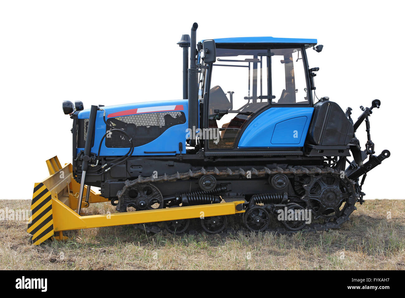 Blue building bulldozer tractor on grass Stock Photo - Alamy