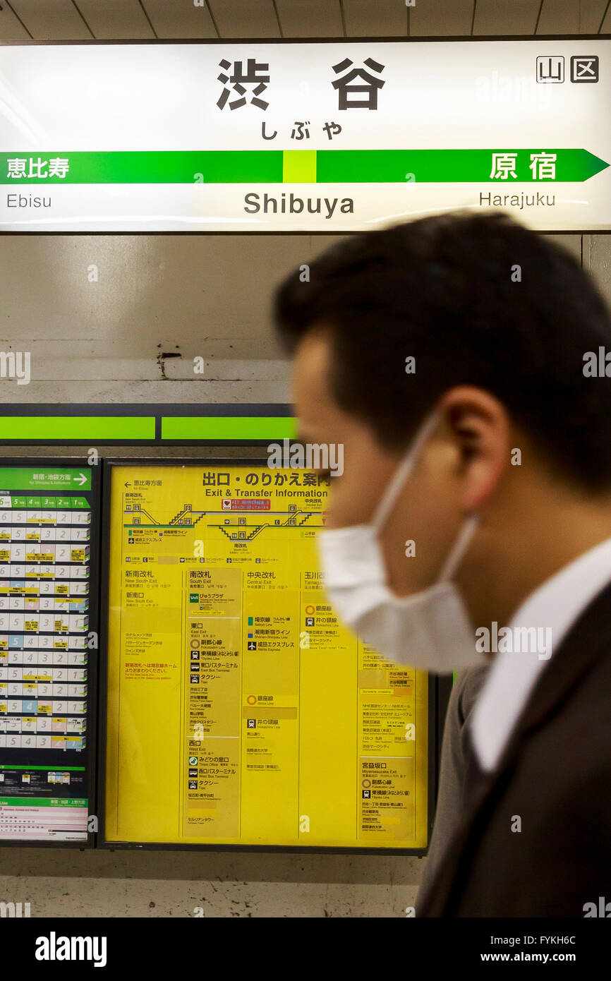A man walks past a Shibuya station signboard on April 27, 2016, Tokyo ...