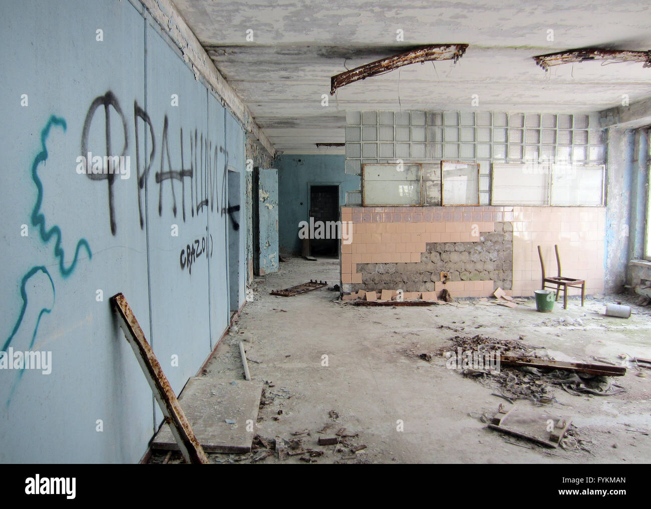 A view of a deserted administration building with graffitti on the wall ...