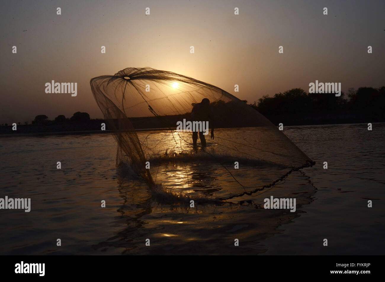 Lahore, Pakistan. 27th Apr, 2016. A Pakistani fisherman casts his net ...