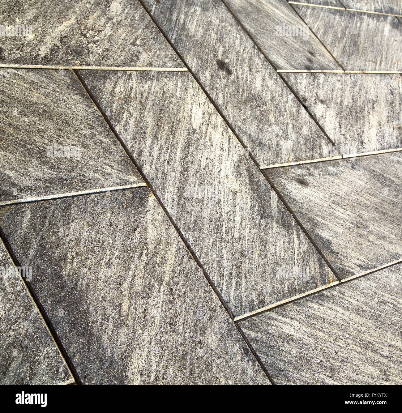 near mozzate street pavement of a curch and wall marble Stock Photo - Alamy