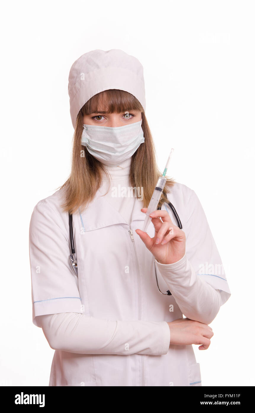Health worker in uniform and mask with syringe Stock Photo - Alamy