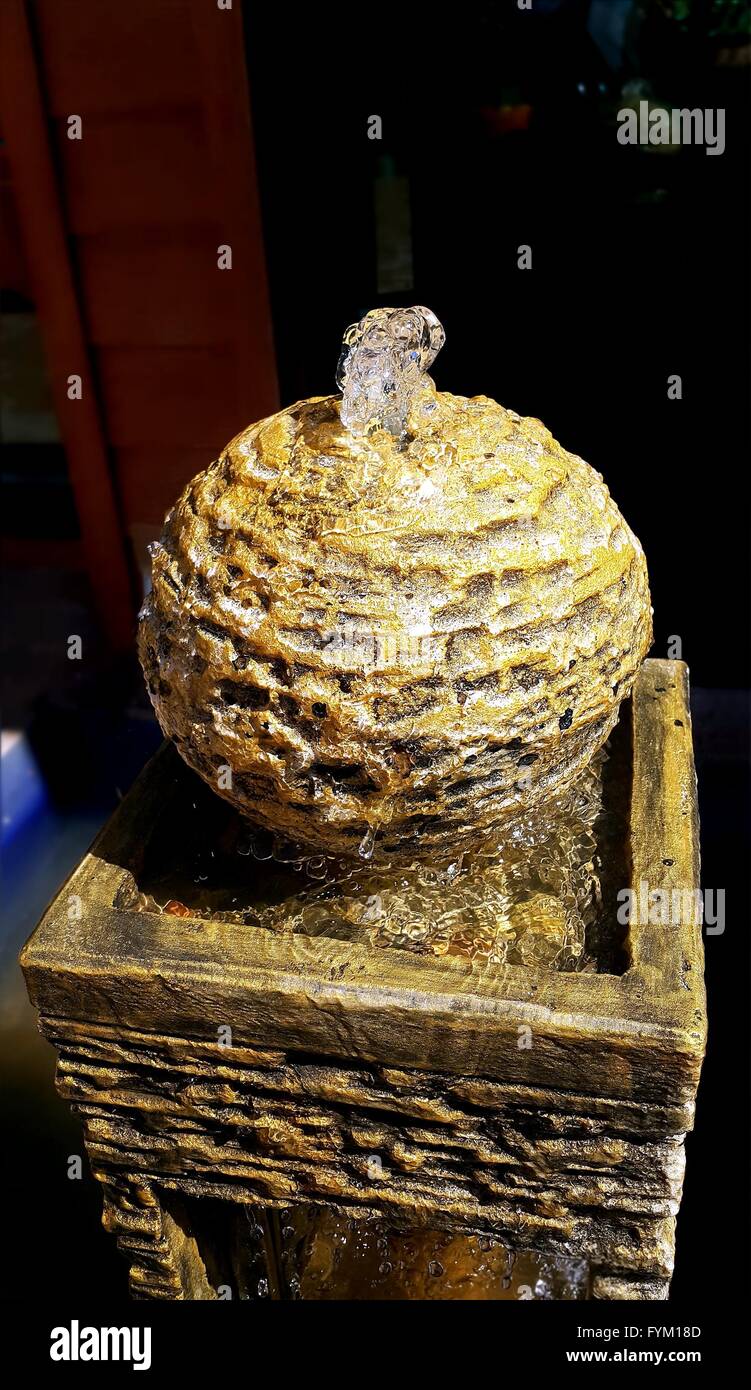 Golden color round stone Fountain Stock Photo - Alamy