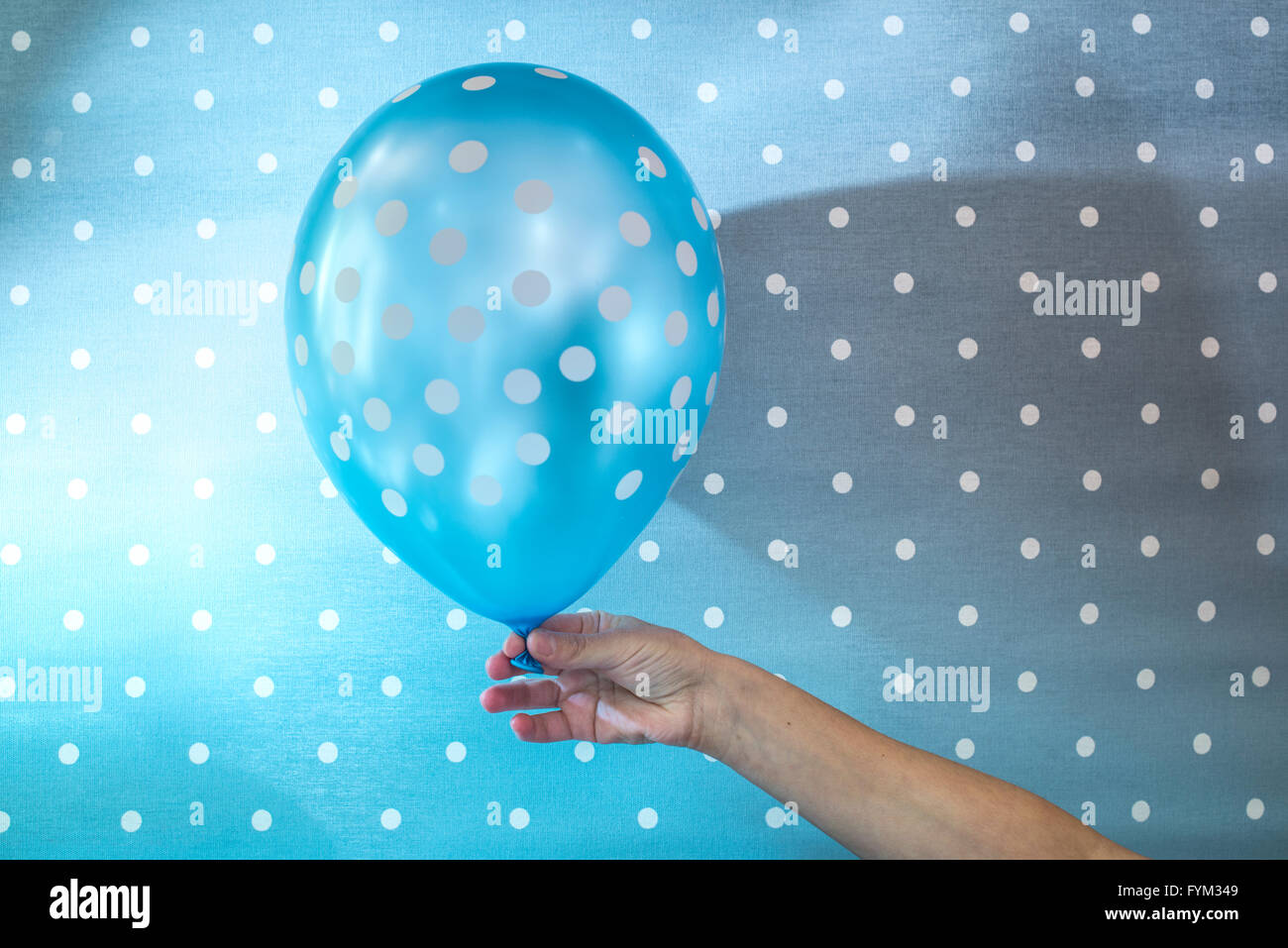 Balloon with white points on blue background Stock Photo - Alamy