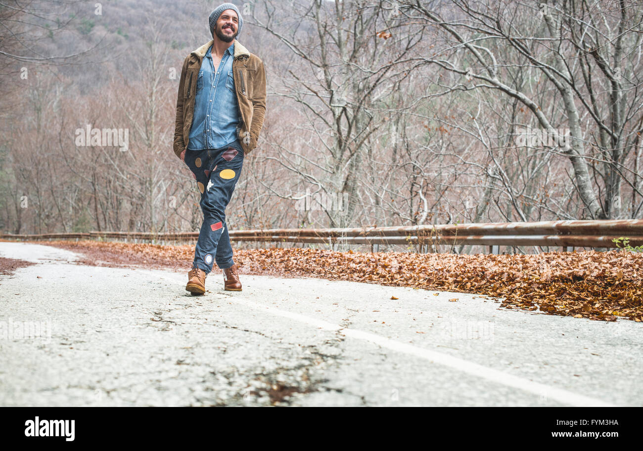 Young men walking on the road Stock Photo - Alamy