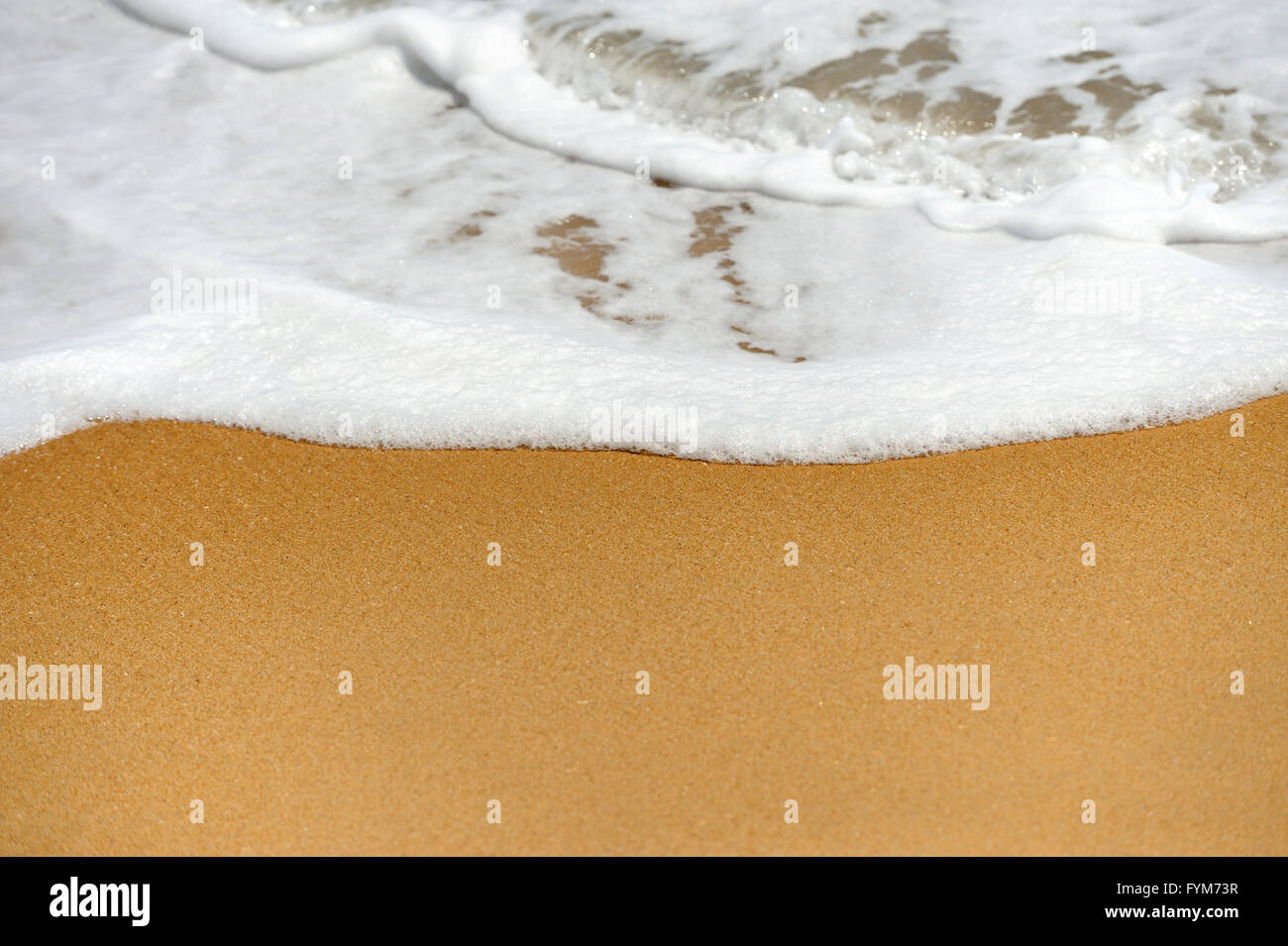 Wave of the ocean on the sand beach Stock Photo - Alamy