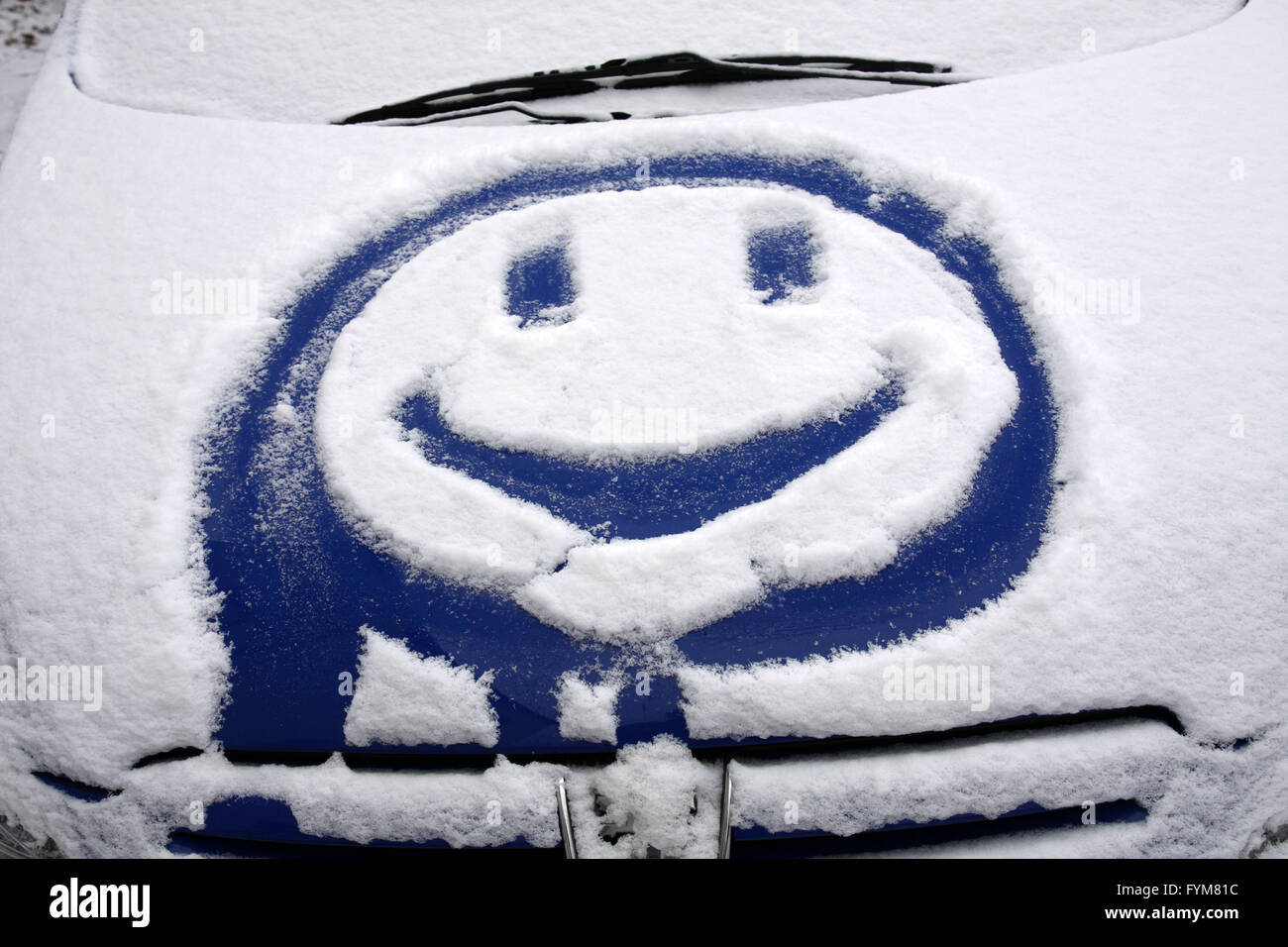 Smiley drawn in the snow Stock Photo - Alamy