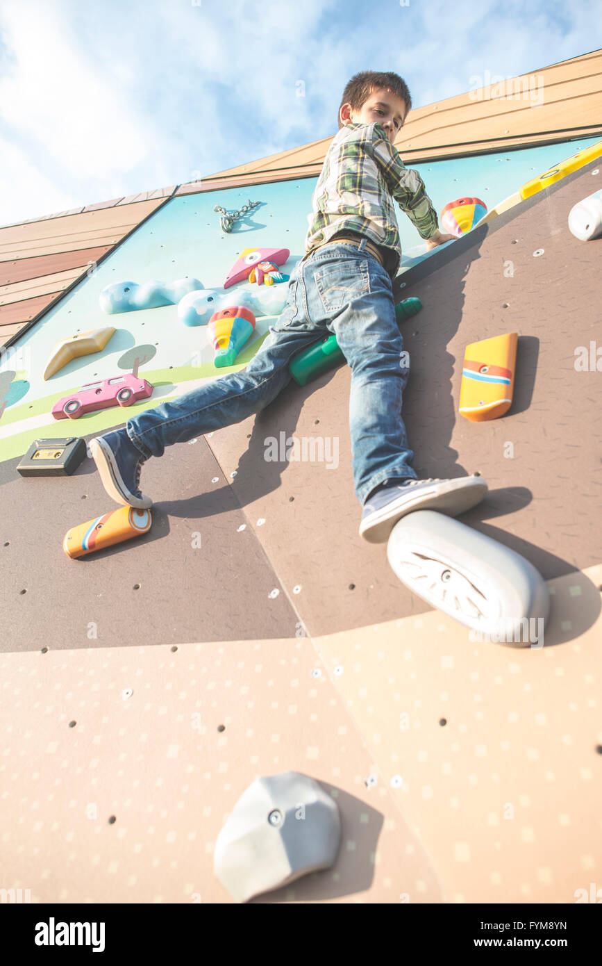 Child climb a climbing wall. Playground Stock Photo - Alamy