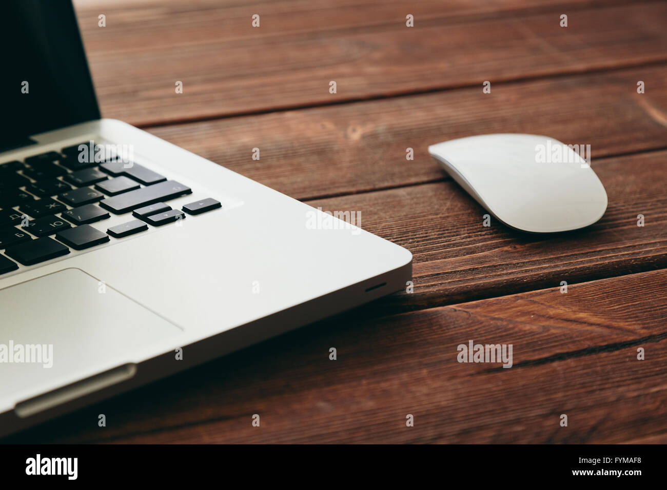 Close-up shot of laptop on old wooden desk Stock Photo - Alamy