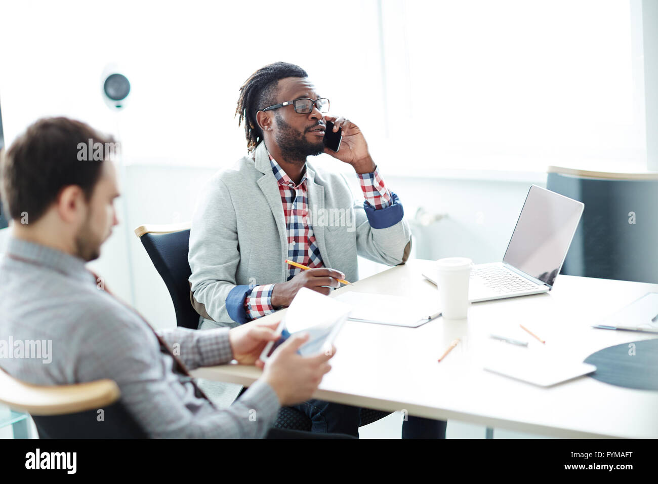 Calling at workplace Stock Photo - Alamy