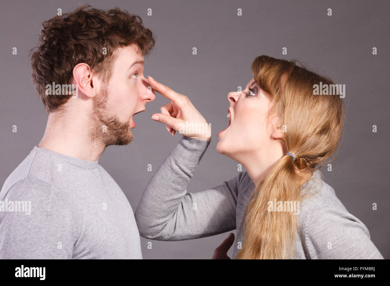 Violence against man. Aggressive woman yelling shouting on scared ...