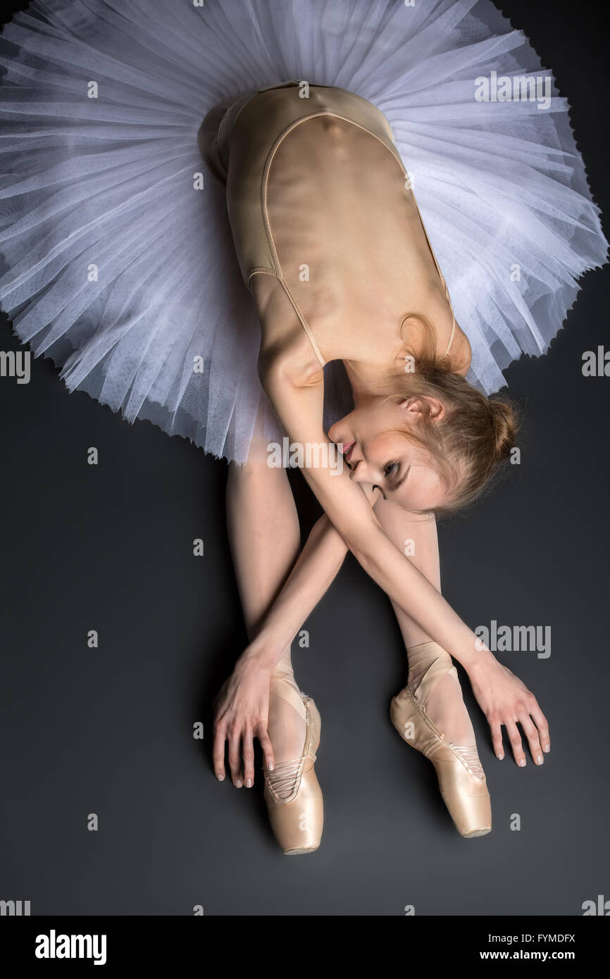 Ballerina sitting on the floor Stock Photo - Alamy