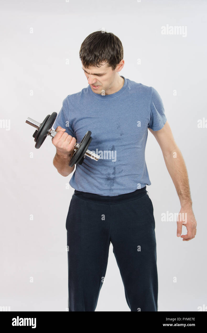 athlete with a last effort raises dumbbell Stock Photo - Alamy