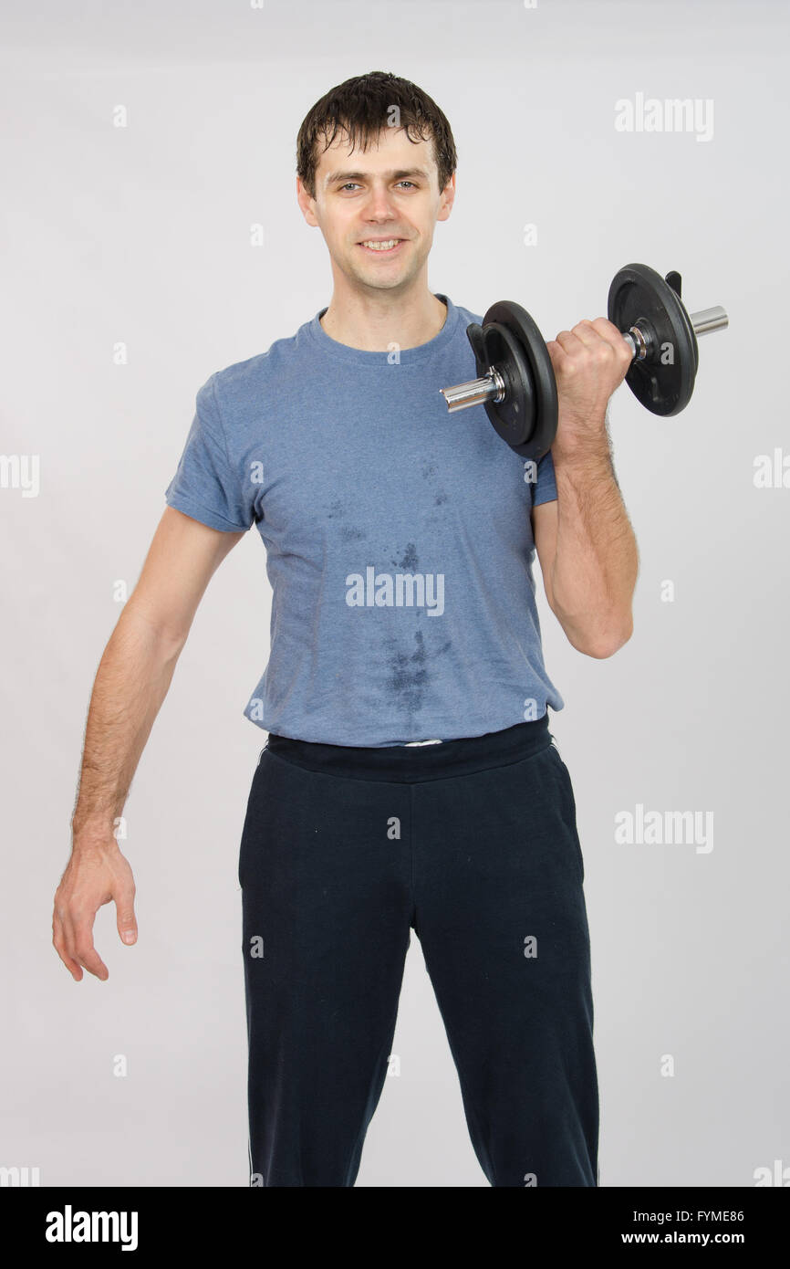 Athlete dumbbell raises his left hand Stock Photo - Alamy