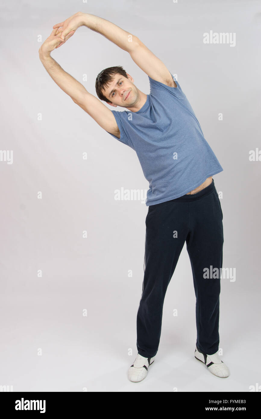 Young man pulls back muscles Stock Photo - Alamy