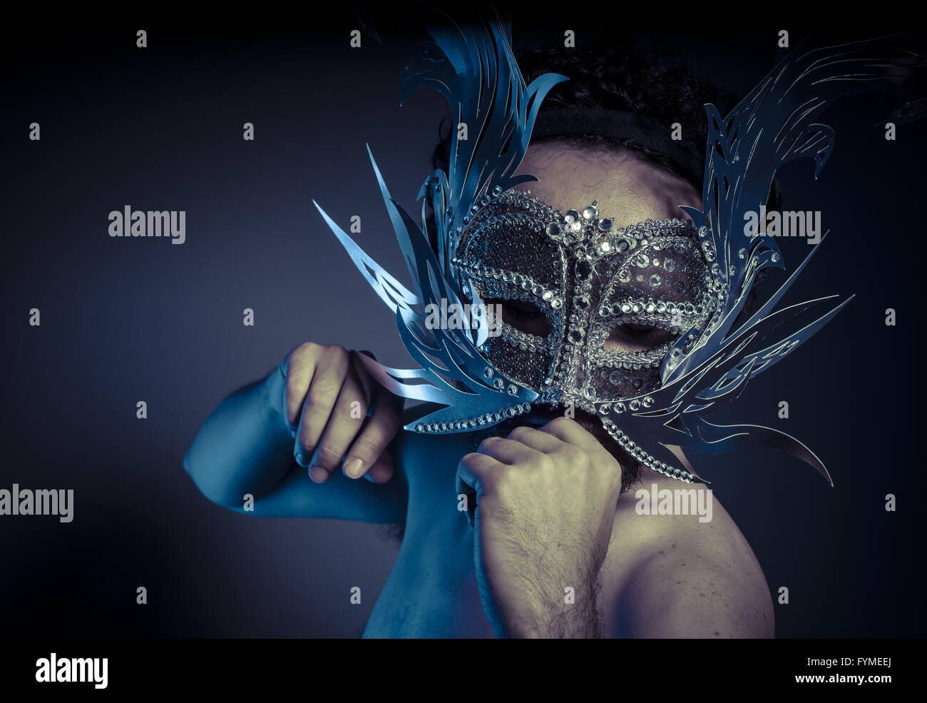 bearded man with silver mask Venetian style. Mystery and renaissance ...