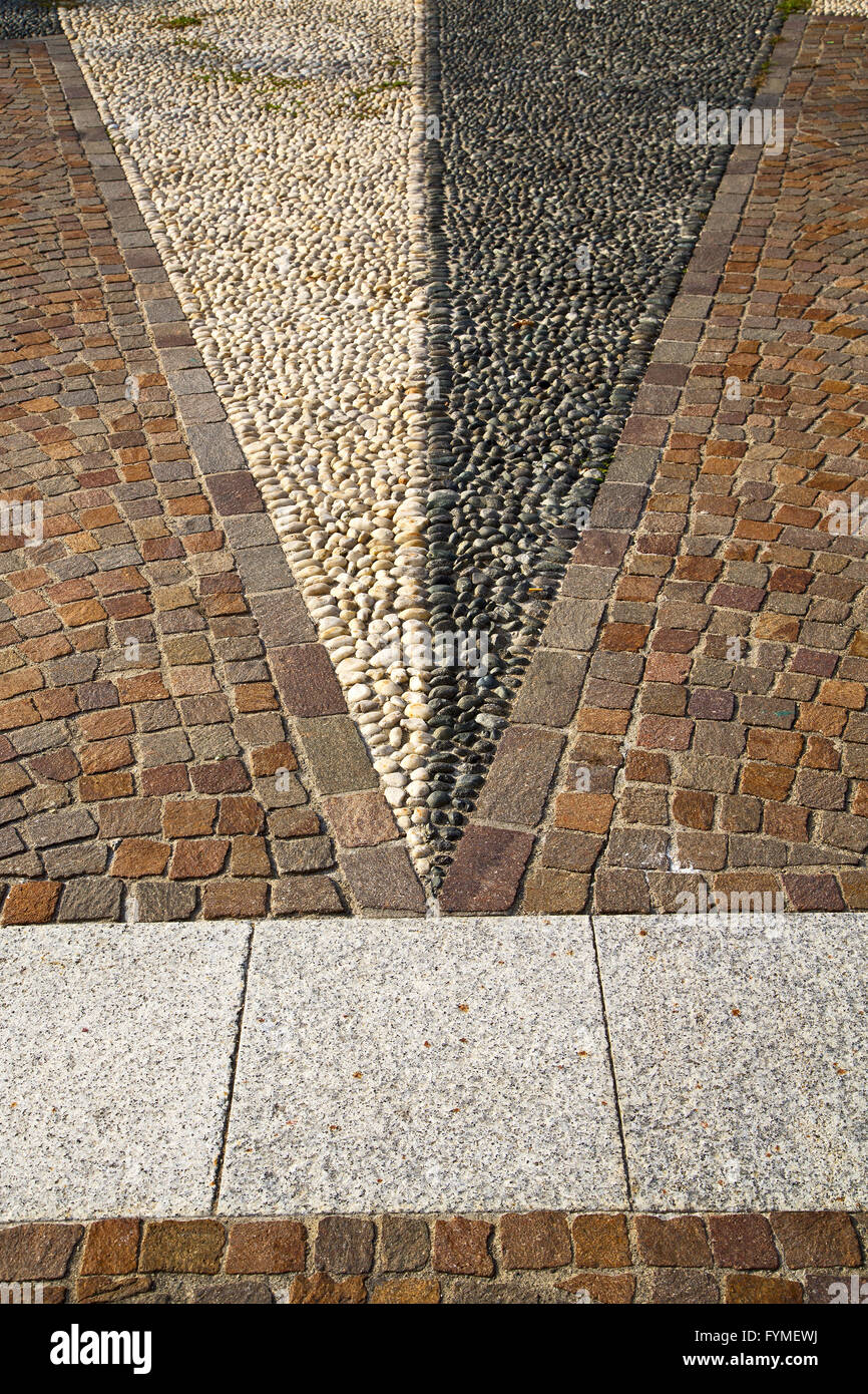 near mozzate street varese abstract pavement of a curch wall marble ...