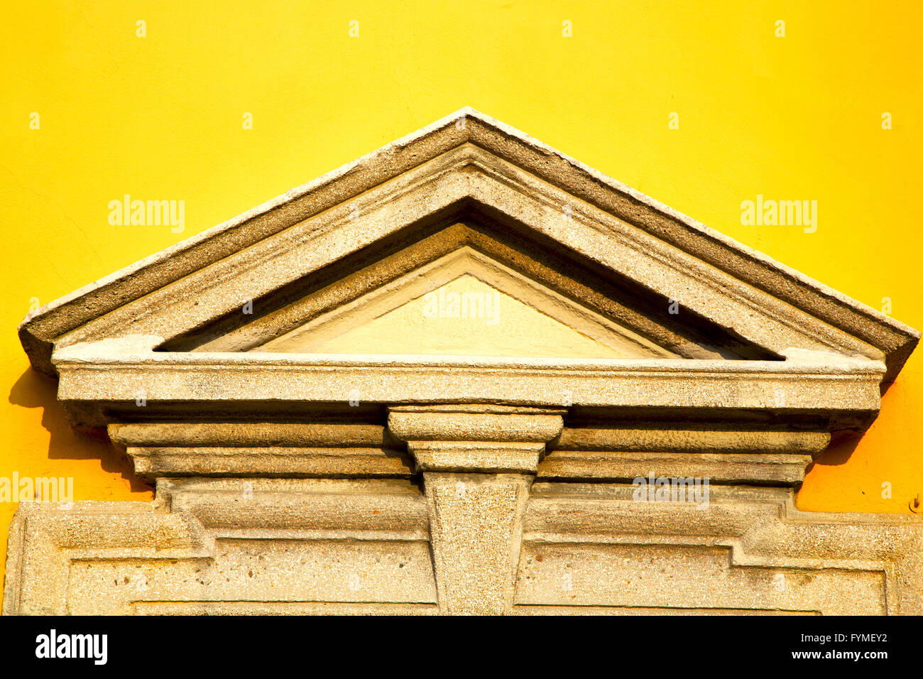 wall milan in italy old church concrete wall yellow triangle Stock ...