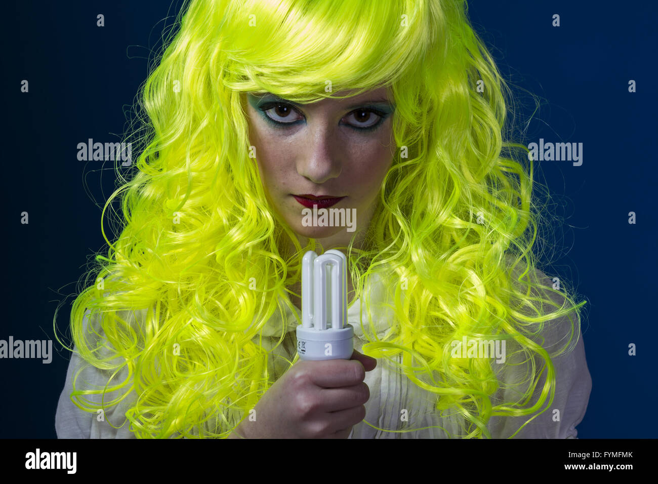 Power, concept electricity, young girl with a light bulb in hand Stock ...
