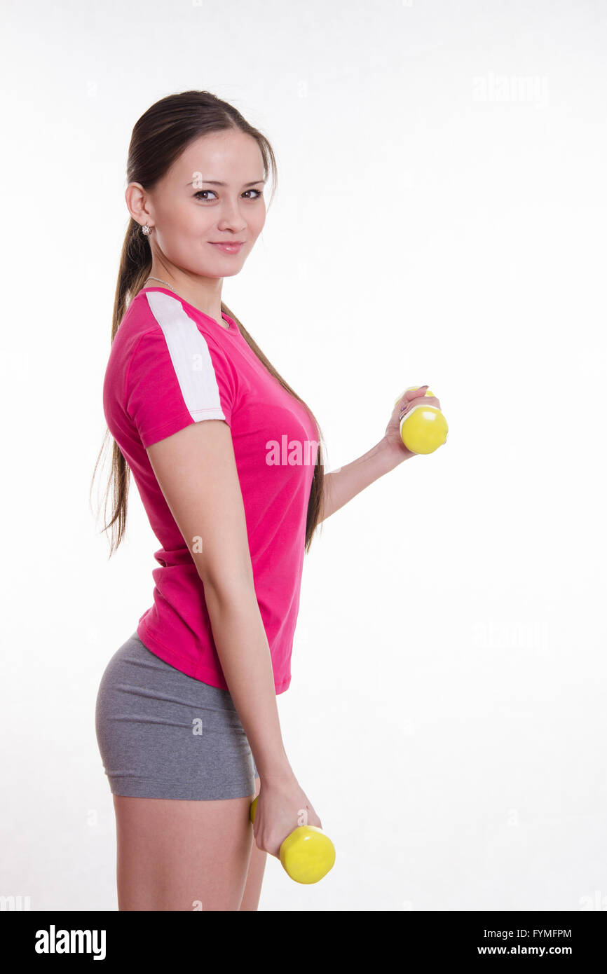 Athlete performs workout two dumbbells Stock Photo - Alamy