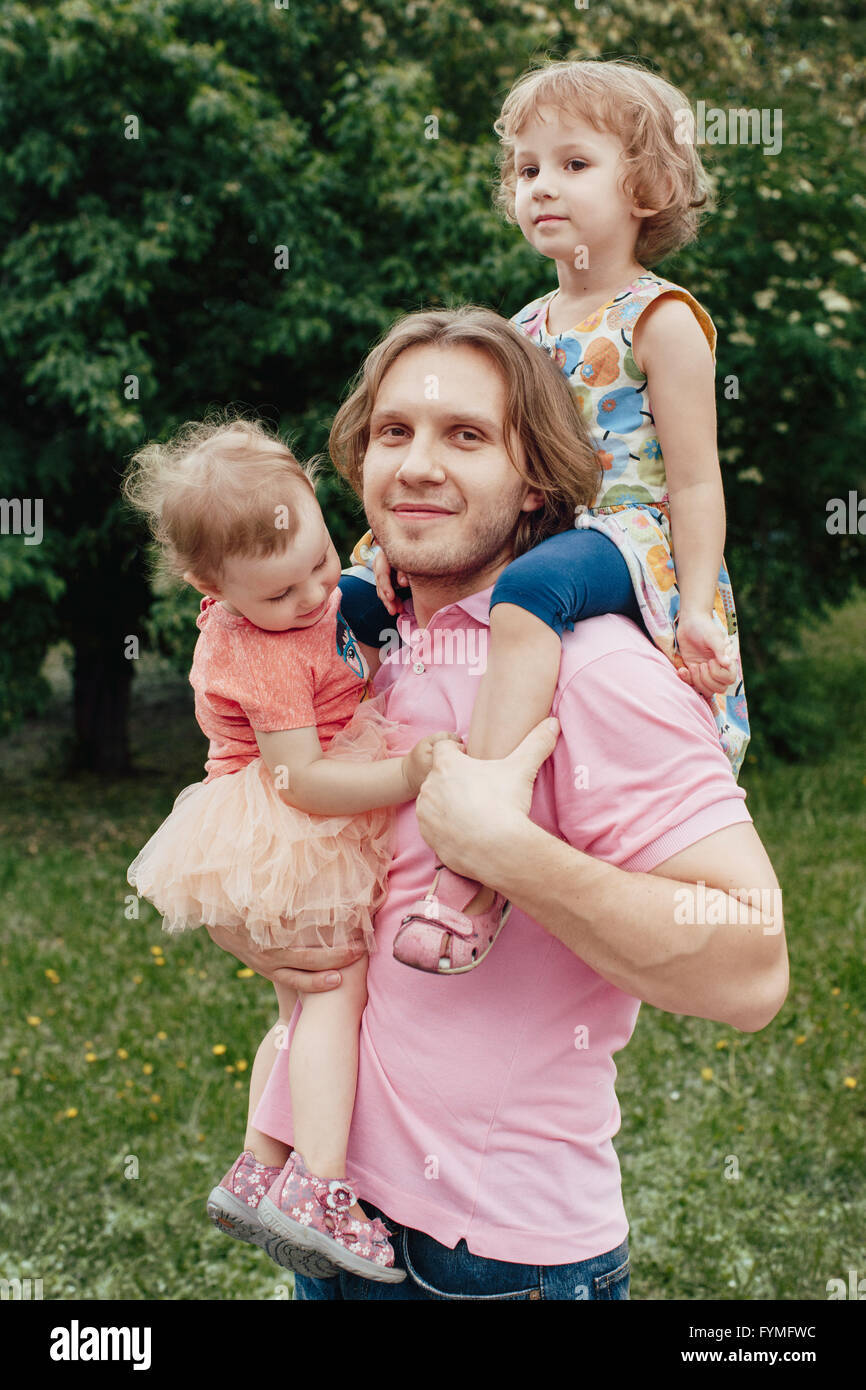 Daddy carrying children on his hands Stock Photo - Alamy