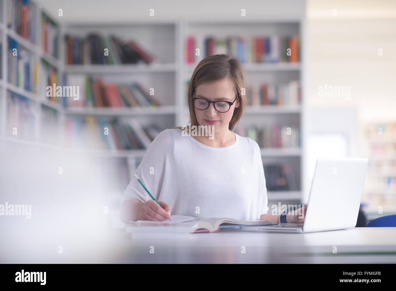 female student study in school library, using laptop and searching for ...