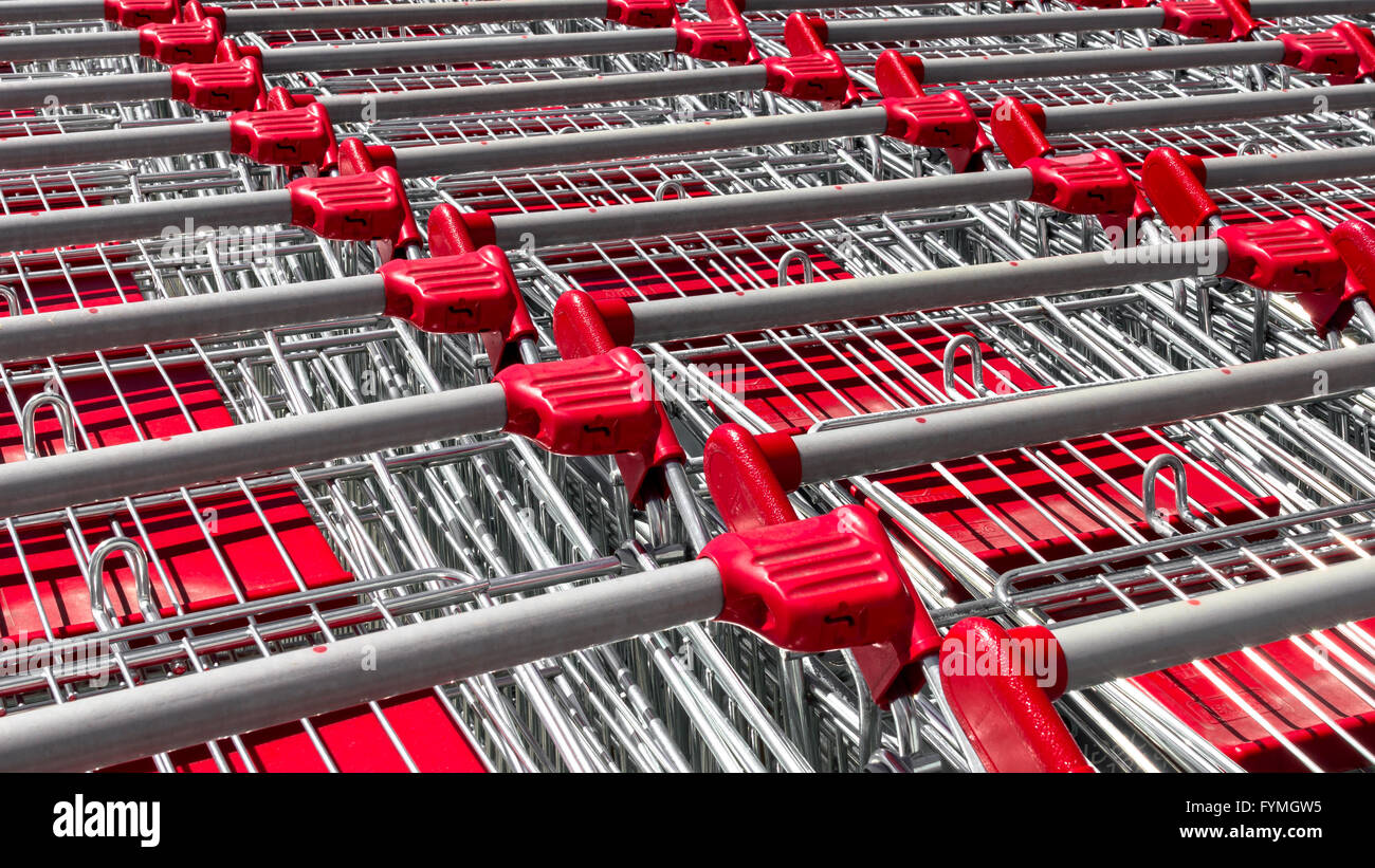 Row of red shopping cart at department store Stock Photo - Alamy