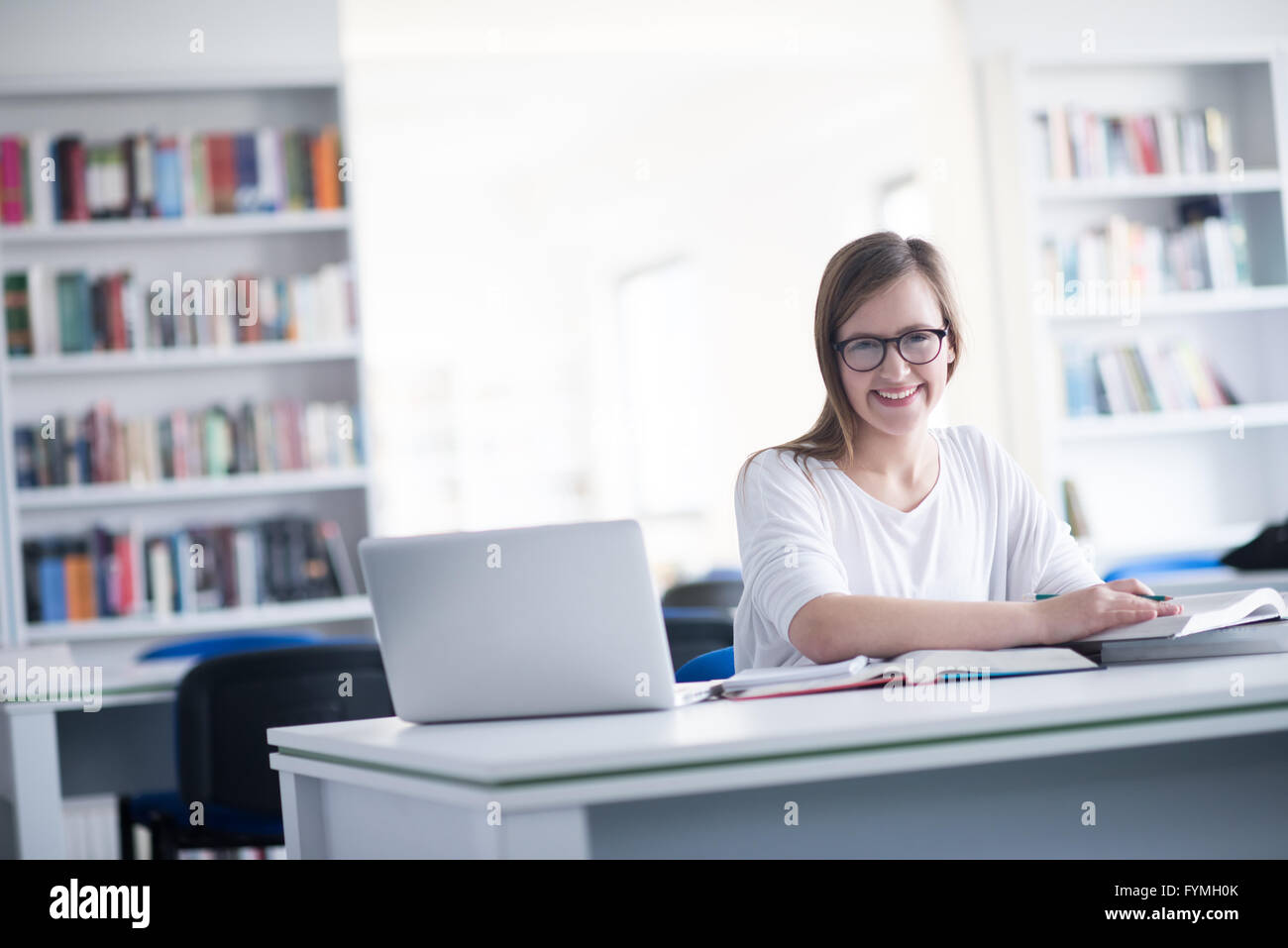 female student study in school library, using laptop and searching for ...