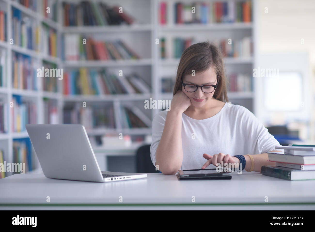 female student study in school library, using laptop and searching for ...