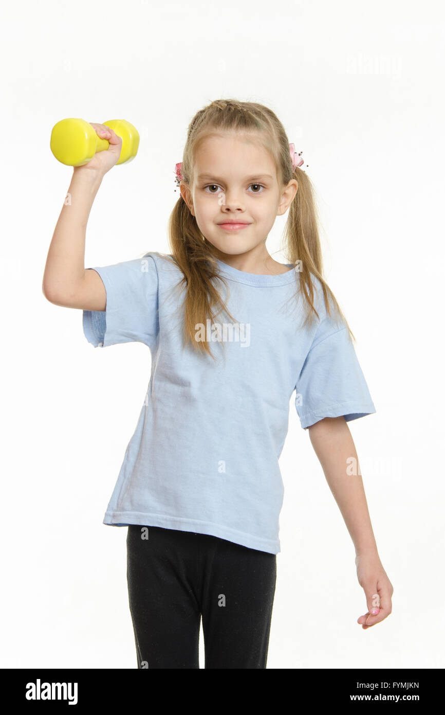 The girl raised her right arm dumbbell Stock Photo - Alamy