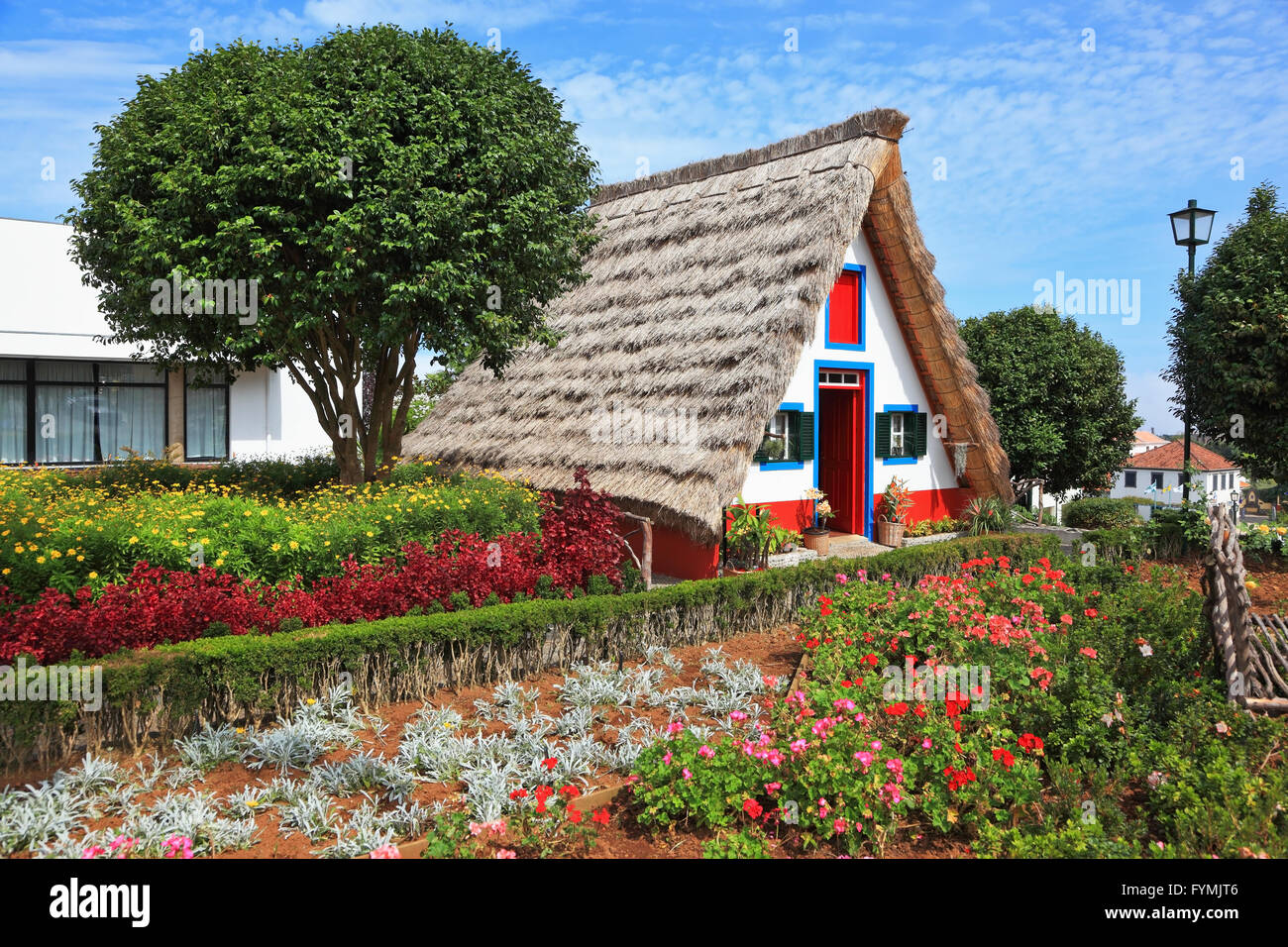 Charming white cottage with a thatched roof gable Stock Photo - Alamy
