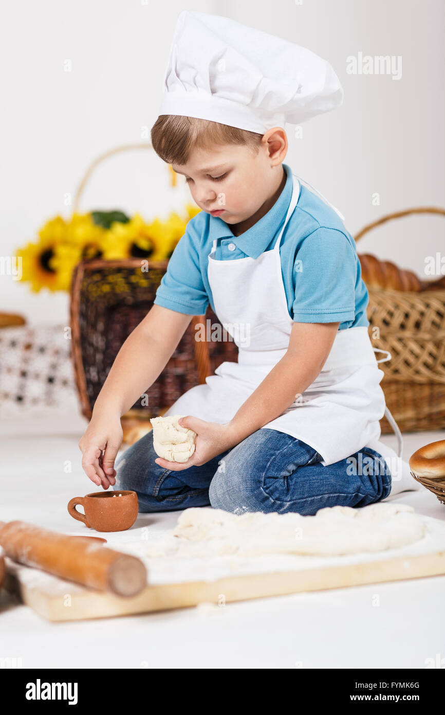 Little boy wearing chef hats baking a pie Stock Photo - Alamy