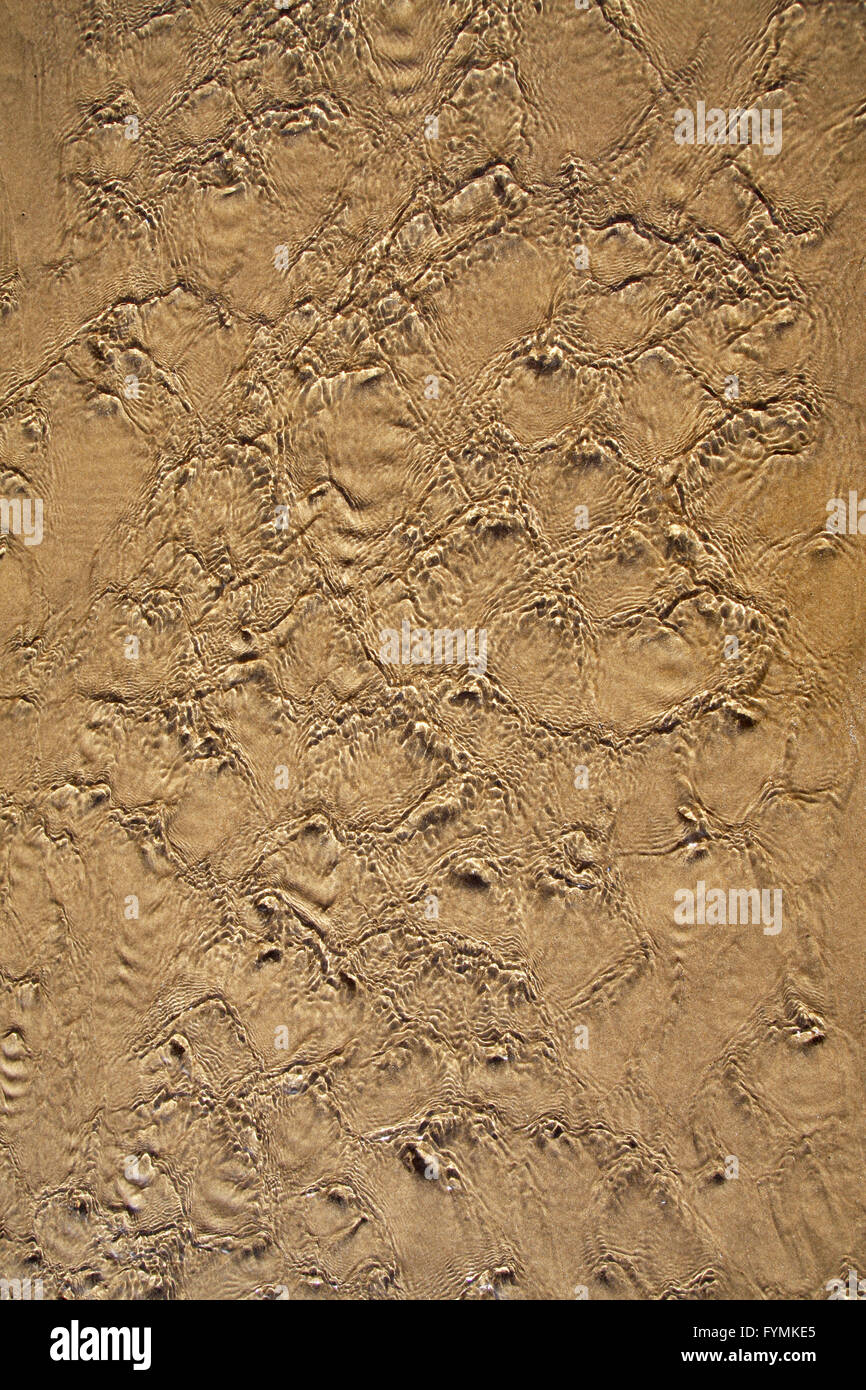 Water flowing over a sandy beach Stock Photo - Alamy