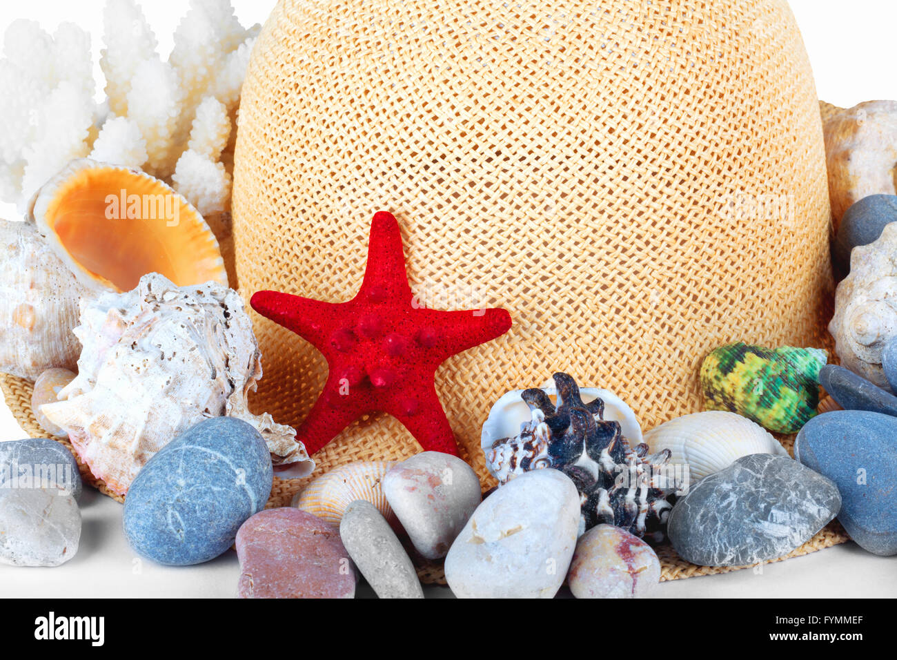 Pretty straw hat with starfish, pebble and mussel Stock Photo - Alamy