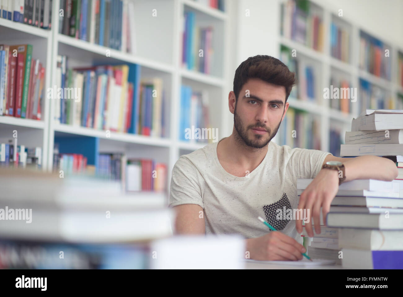 Student reading book in school library. Study lessons for exam. Hard ...