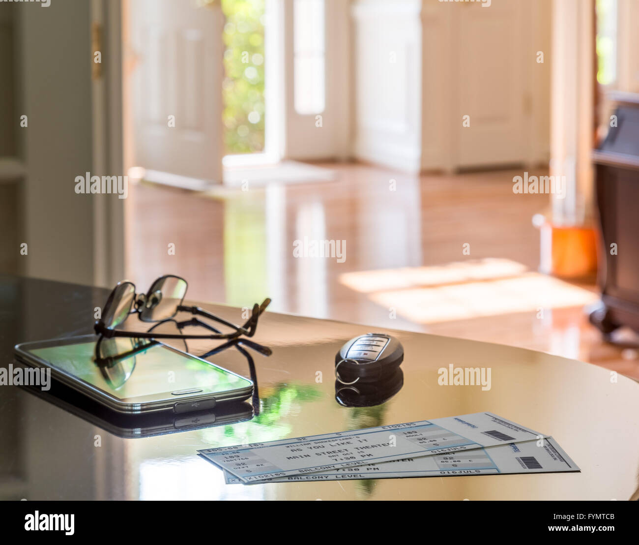 Pair of theater tickets on table with front door Stock Photo - Alamy