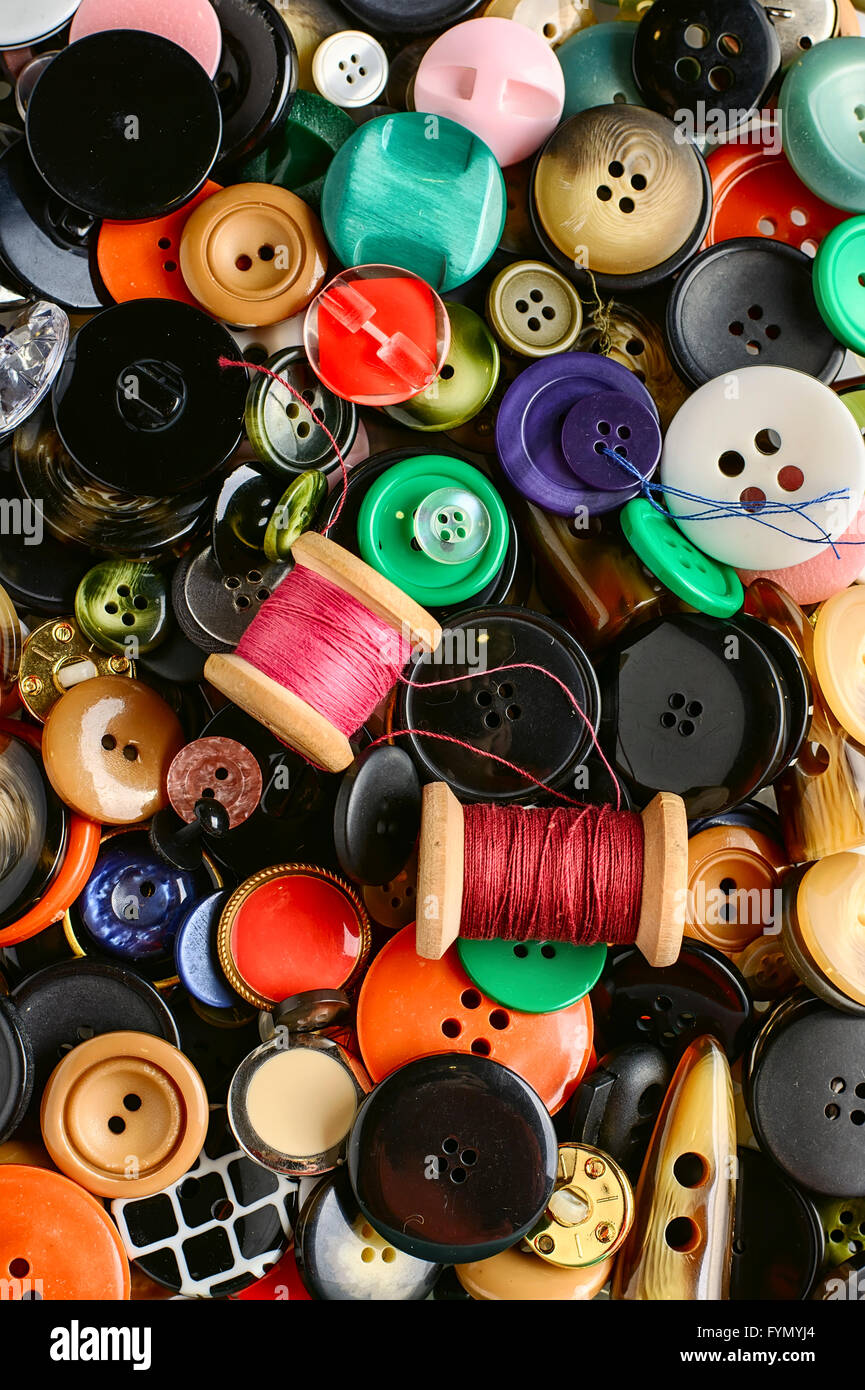 Set of various sewing buttons and thread.Top view Stock Photo - Alamy