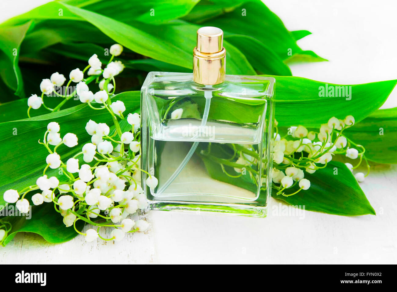 Lily of the valley perfume with flowers bouquet and perfume bottle ...