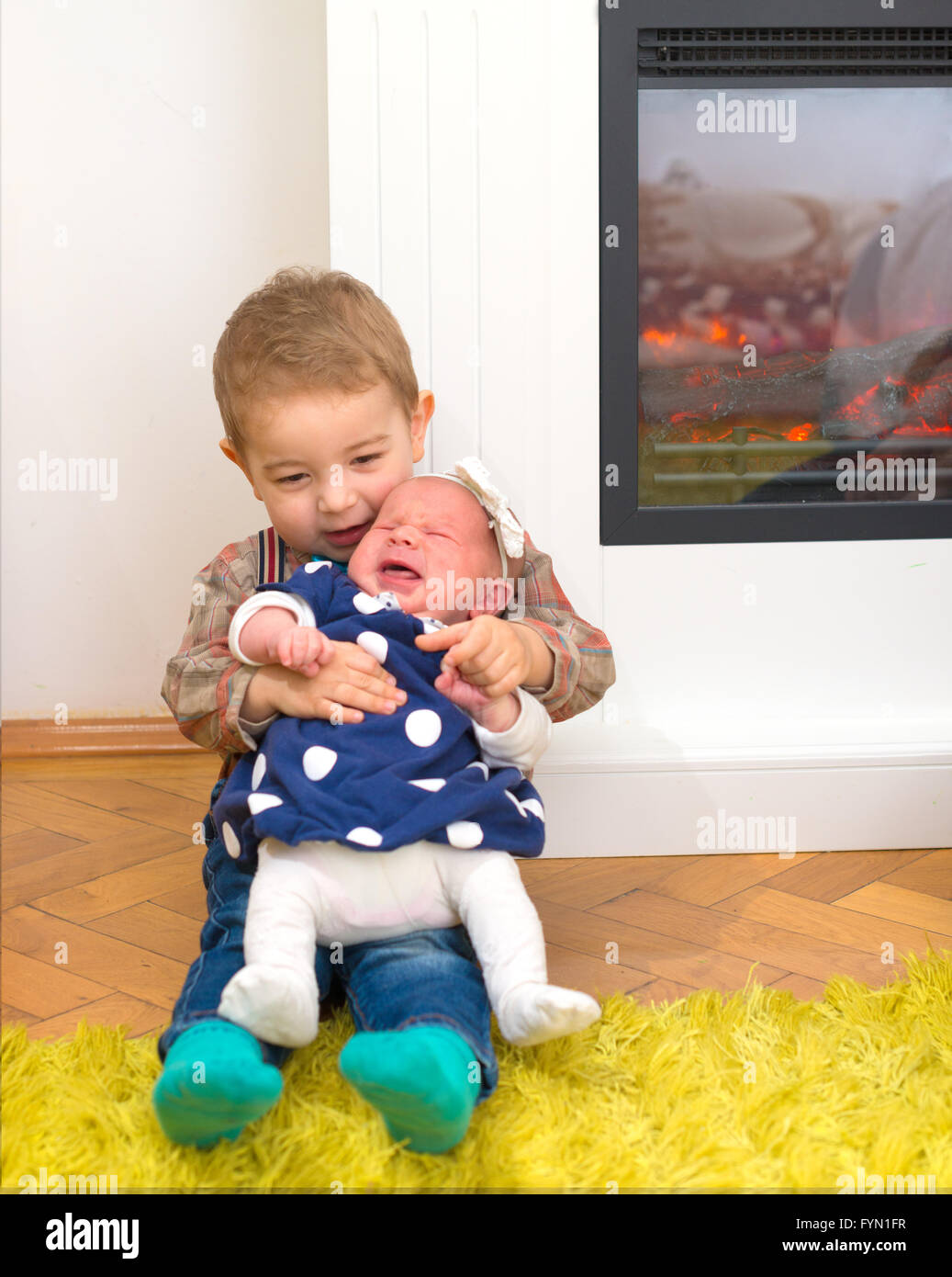 brother holding his newborn baby sister Stock Photo - Alamy