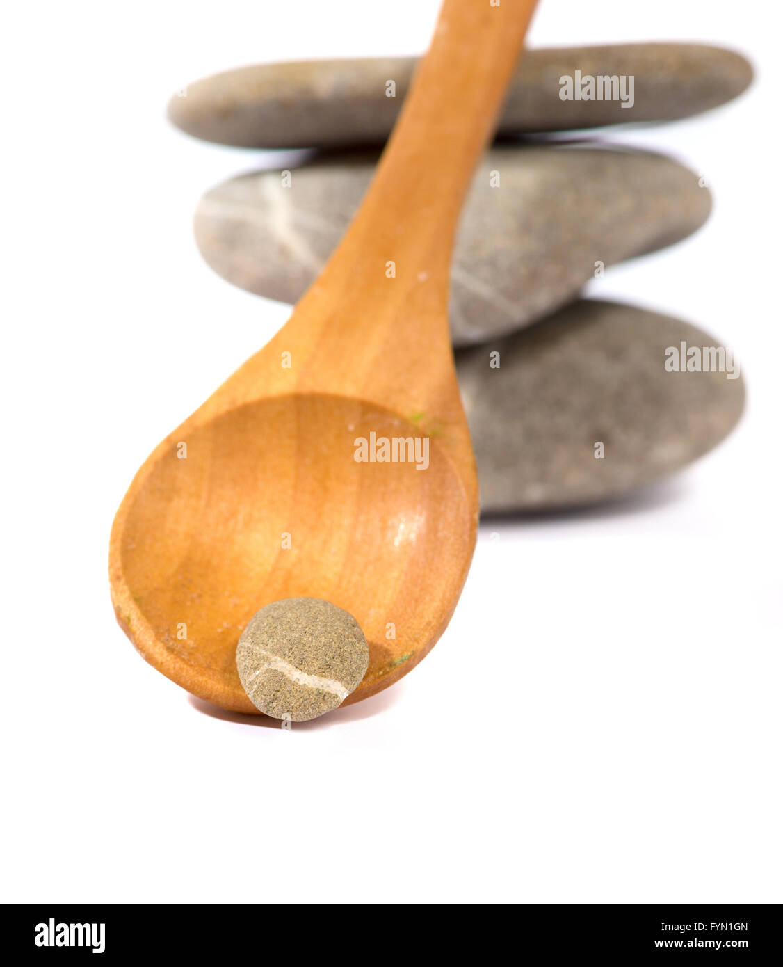 Close up view of wooden spoons and stone isolated on white background ...