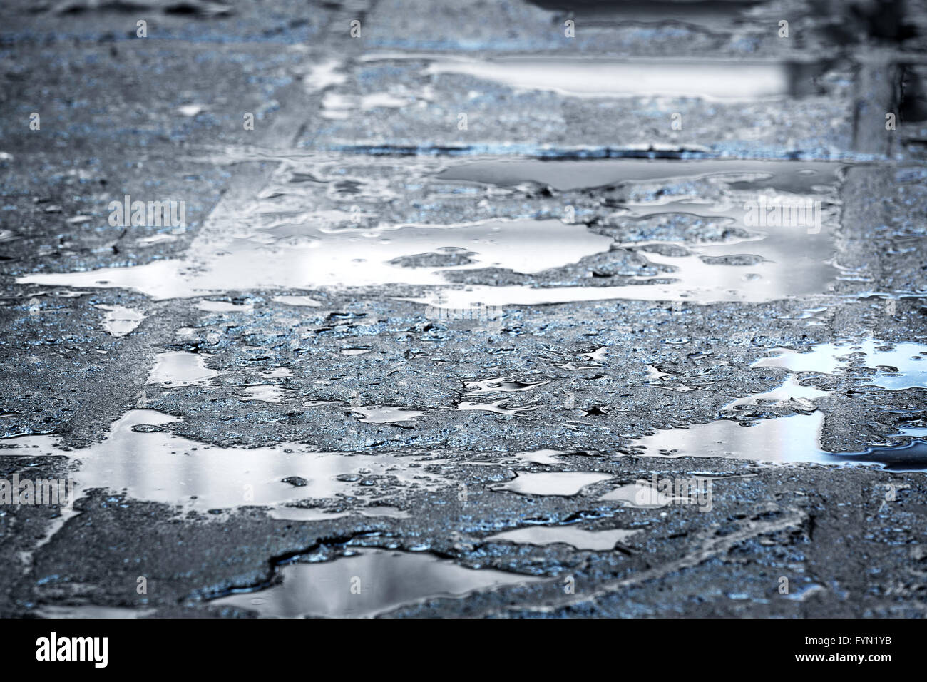 rain puddles on a pavement Stock Photo - Alamy