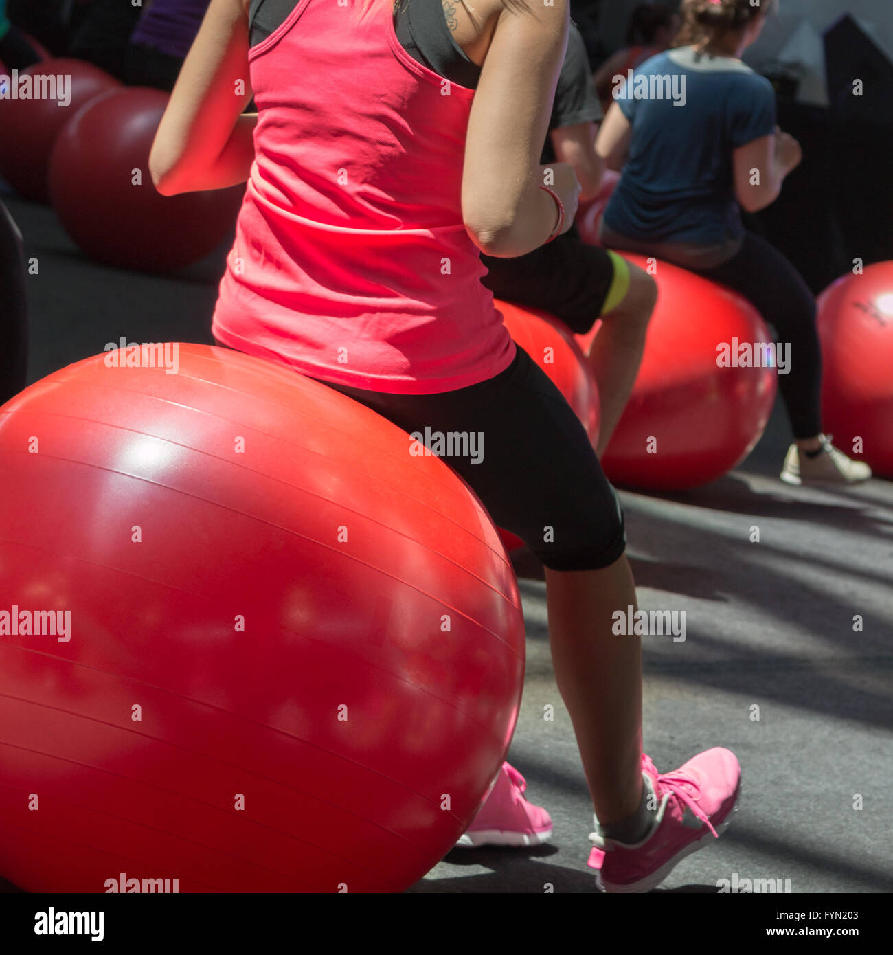 Closeup of Girl doing Fitness Activity Sitting on Big Red Ball in Gym ...