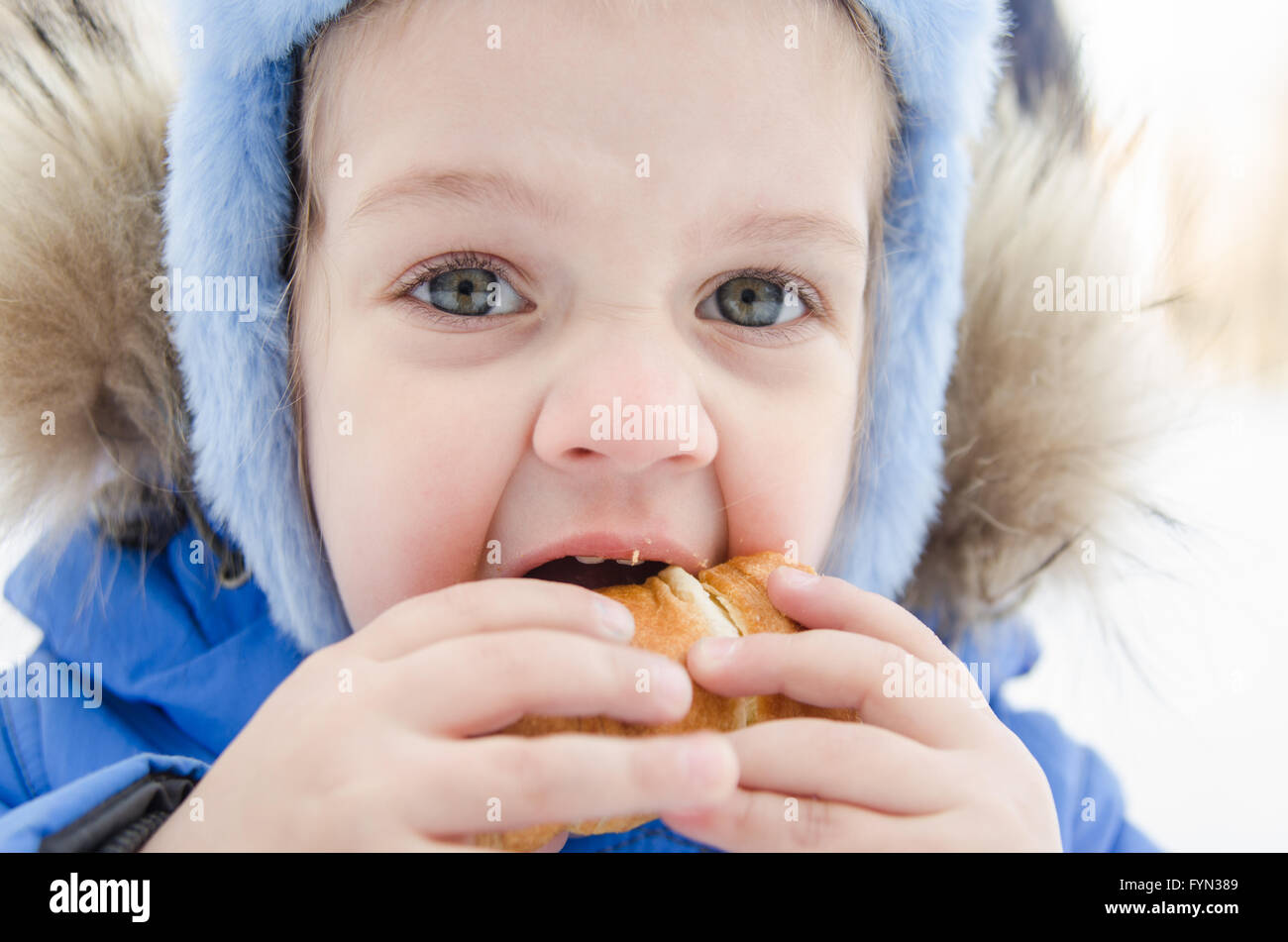 Girl eating a roll Stock Photo - Alamy
